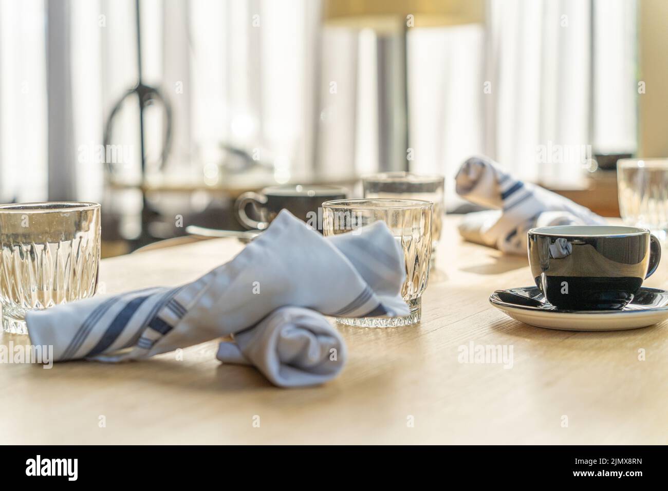 Glass with restaurant table place setting Stock Photo - Alamy