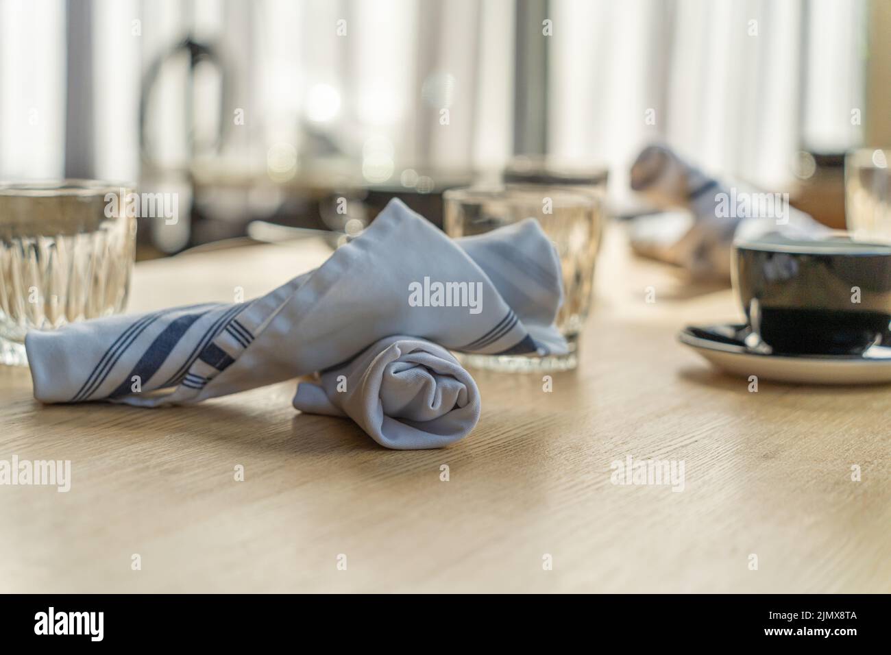 Glass on restaurant table place setting Stock Photo - Alamy
