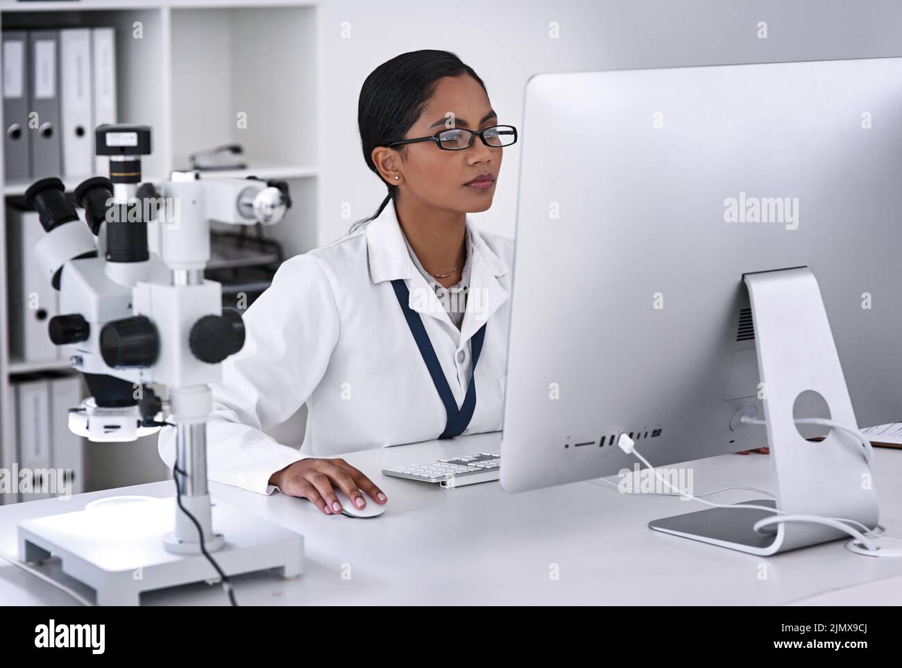 Science reveals all. an attractive young female scientist working on ...