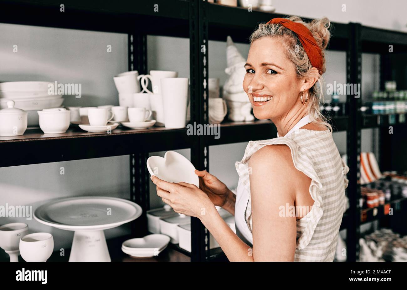 Organising my shelf the way I like it. Cropped portrait of an ...