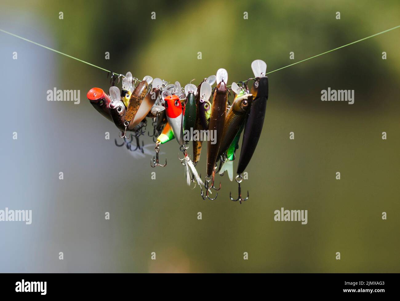 Different type fish lure hanging fishing line Stock Photo - Alamy