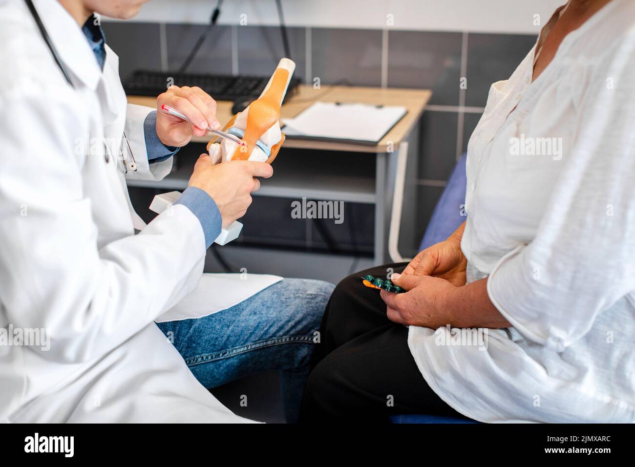 Doctor hands showing bone joints patient Stock Photo - Alamy