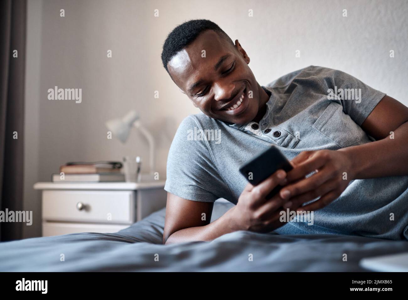 Handsome man lying on bed hi-res stock photography and images - Alamy
