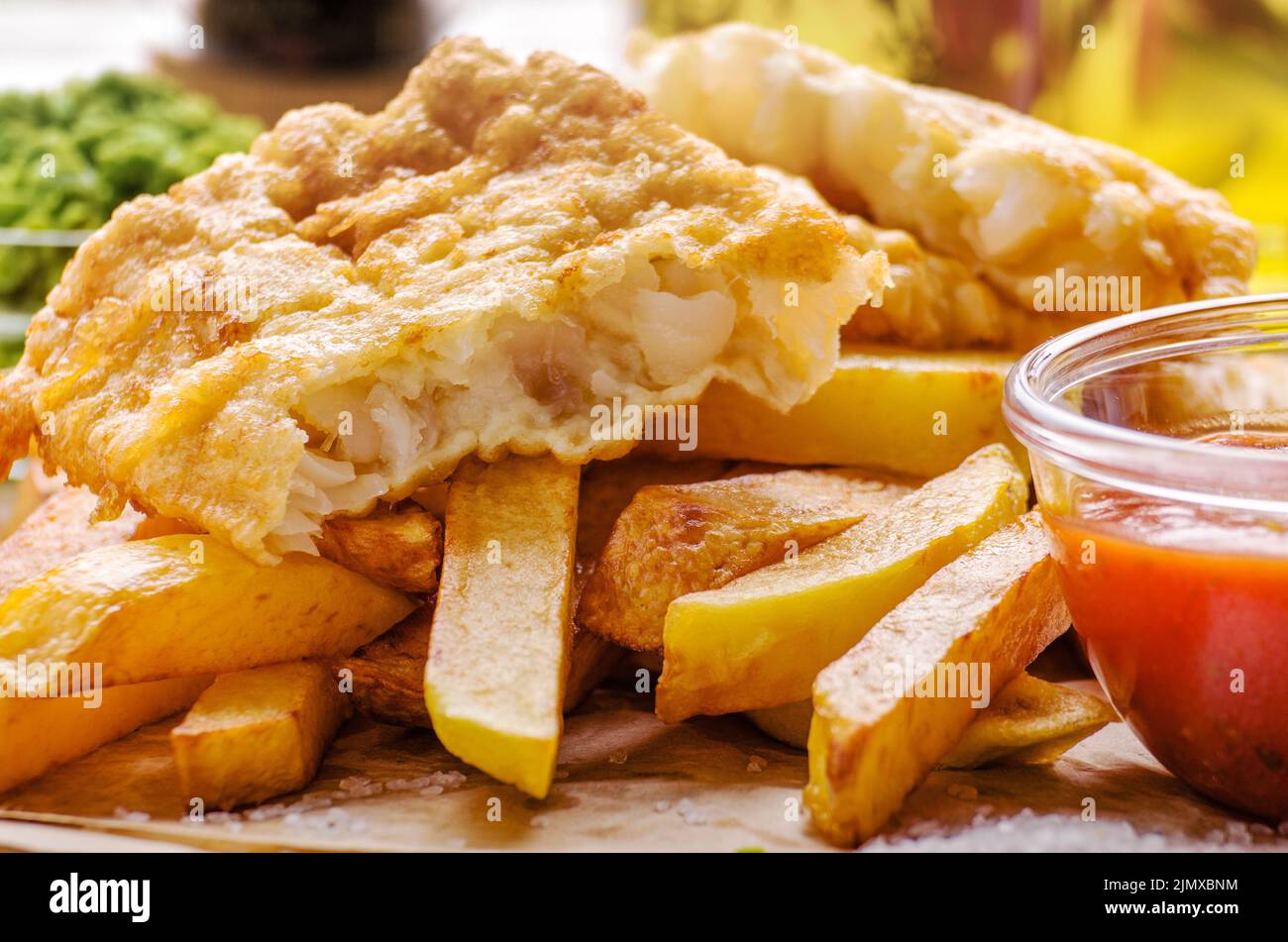 Traditional British street food fish and chips with ketchup sauce on ...