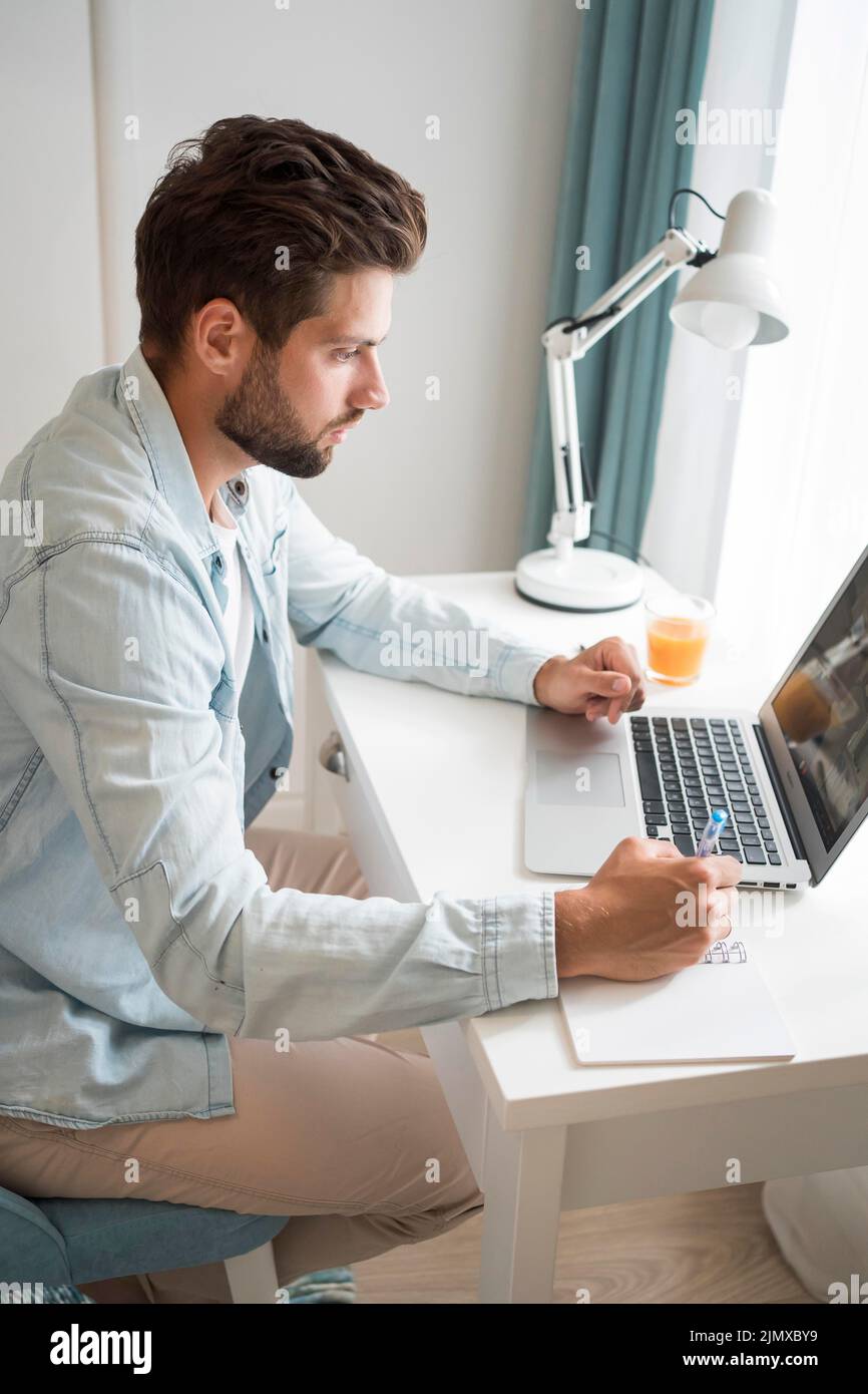 Cheerful young man working home hi-res stock photography and images - Alamy