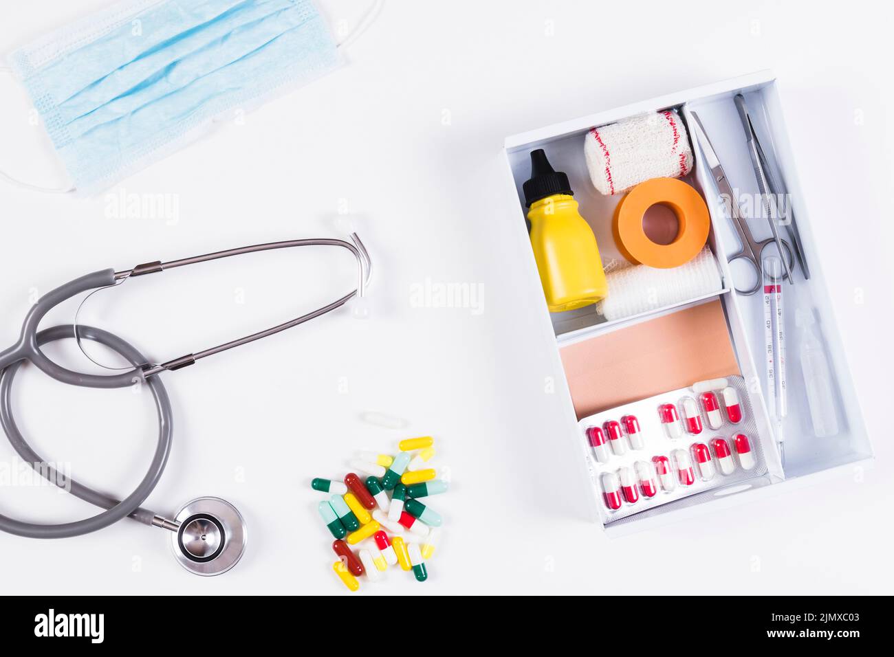 Colorful capsules stethoscope mask with first aid kits white background ...