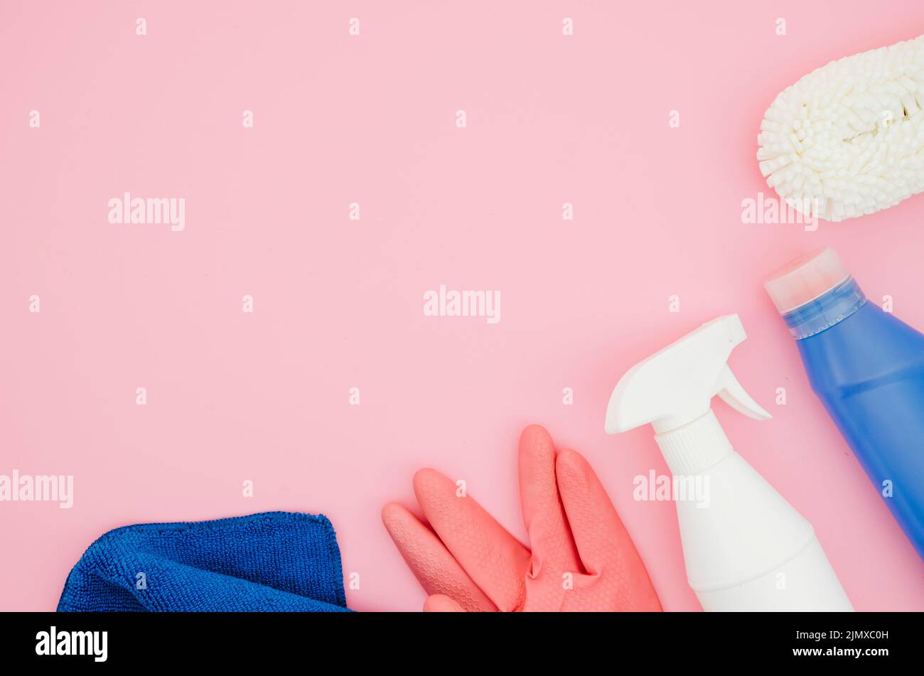 Cleaning supplies pink background Stock Photo - Alamy