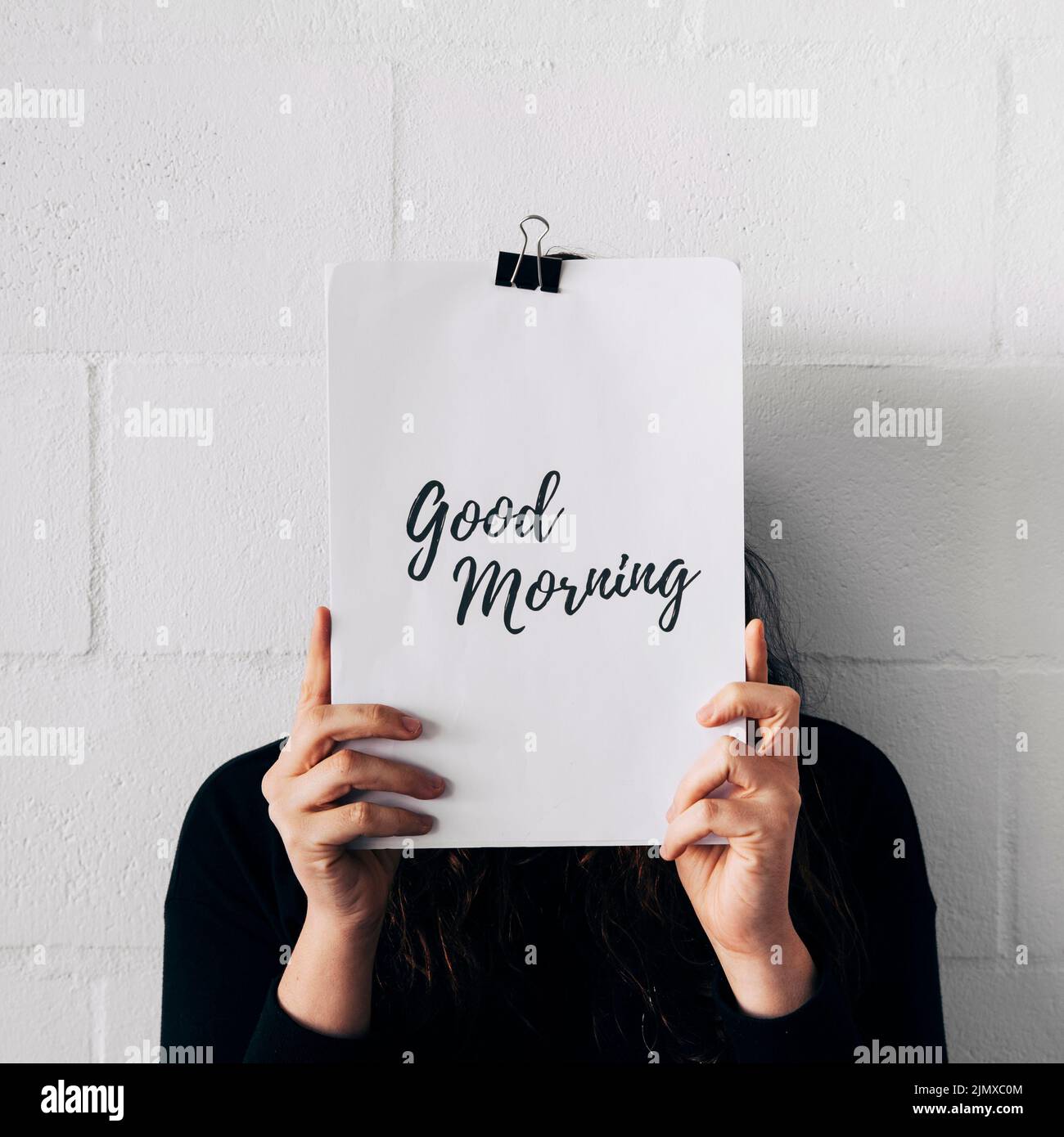 Close up female holding paper attach with paperclip good morning text ...