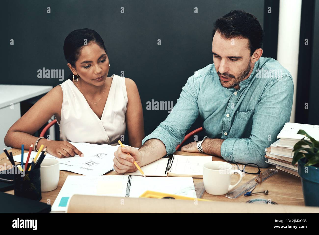 They make a great team together. two young architects working together ...
