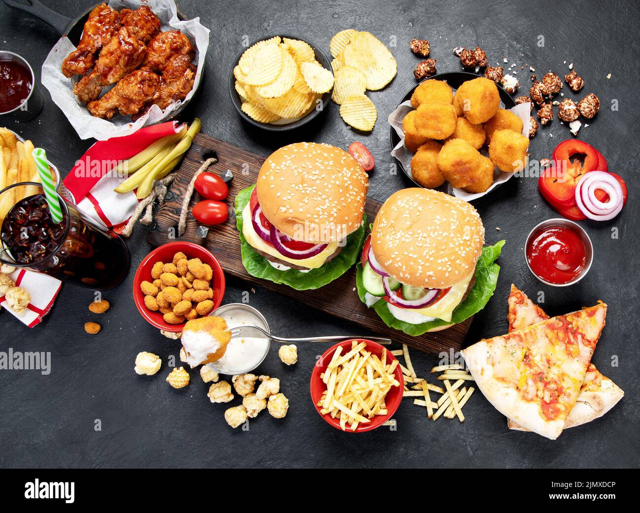 Fast food and unhealthy eating concept - close up of fast food snacks ...