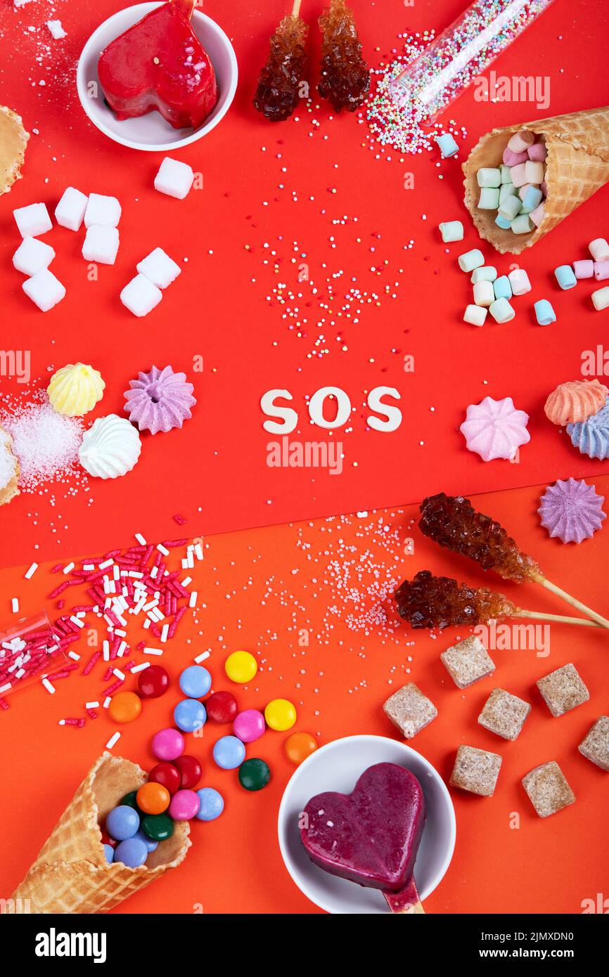 Mix of sweets and candy with sugar spread and written text in unhealthy ...