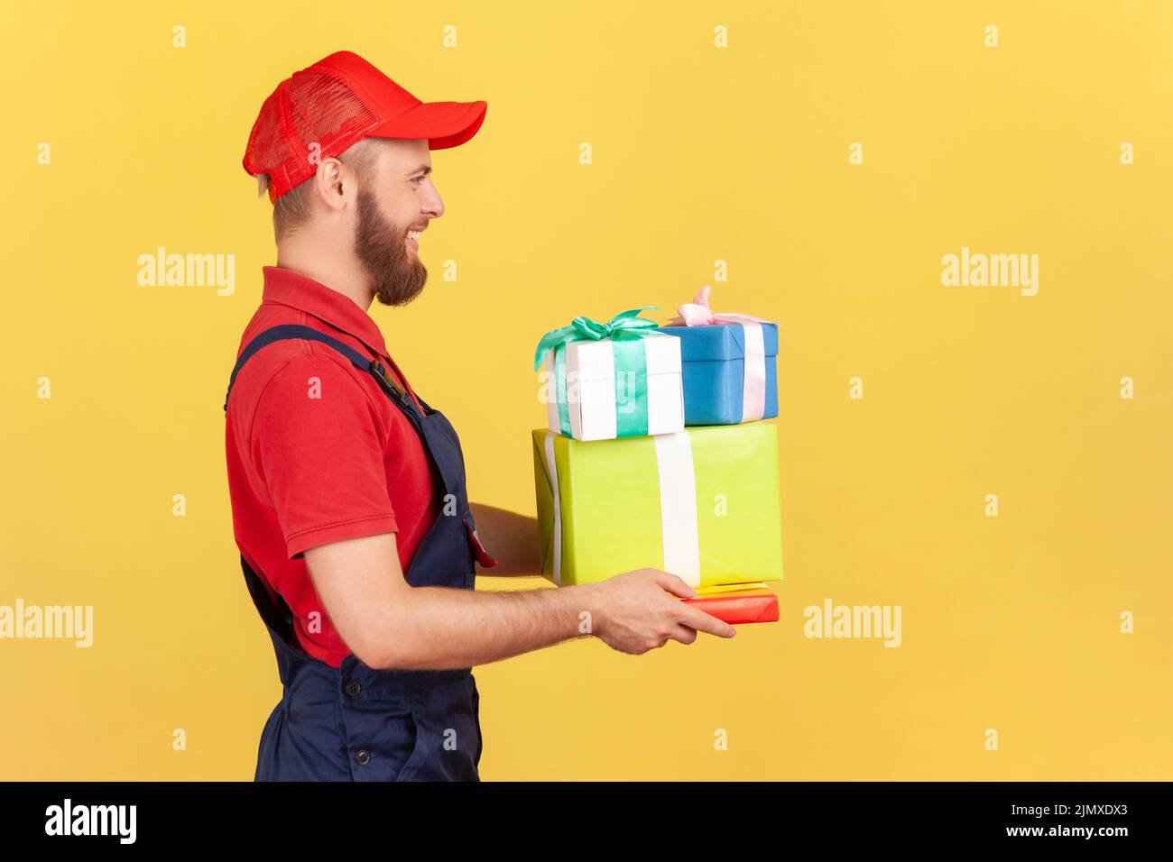 Side view portrait of positive happy courier man wearing uniform and ...