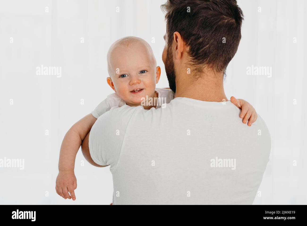 Back view father holding baby Stock Photo - Alamy