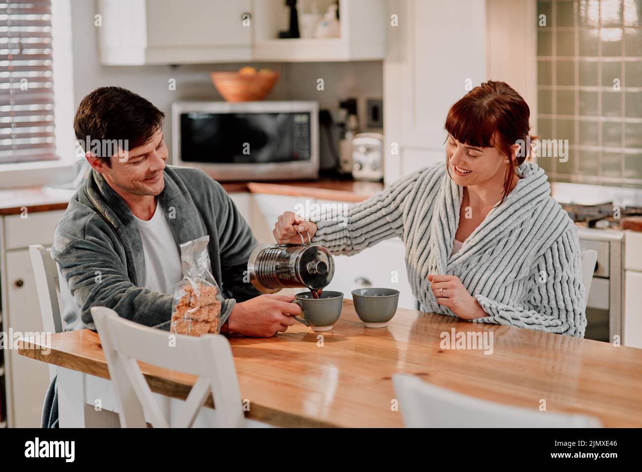 Lets have our coffee and get this day started. a couple having their ...