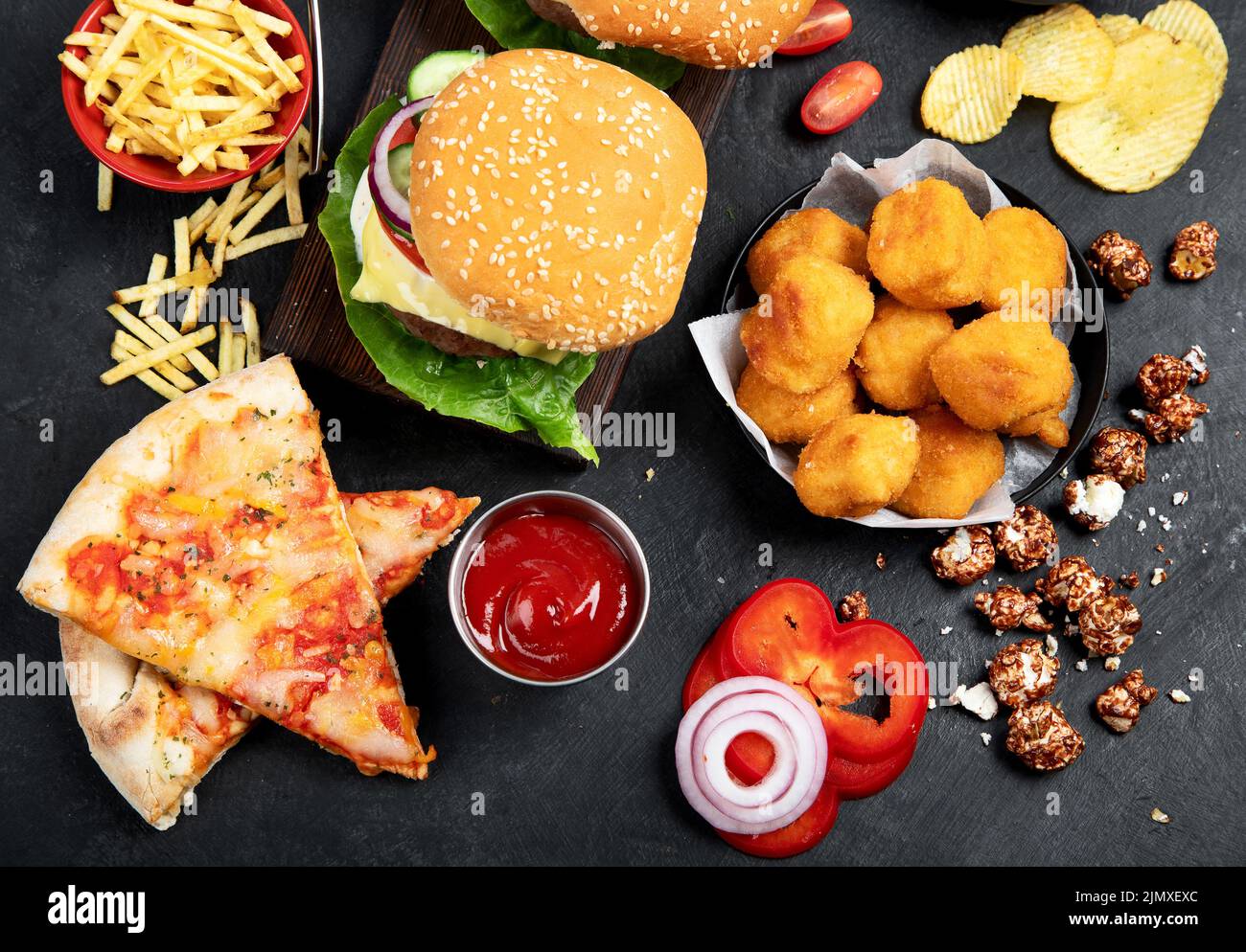 Fast food and unhealthy eating concept - close up of fast food snacks ...