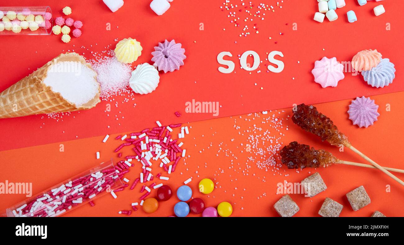 Mix of sweets and candy with sugar spread and written text in unhealthy ...