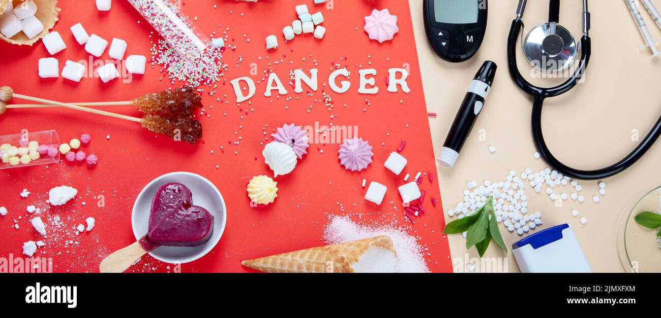 Mix of sweets and candy with sugar spread and written text in unhealthy ...