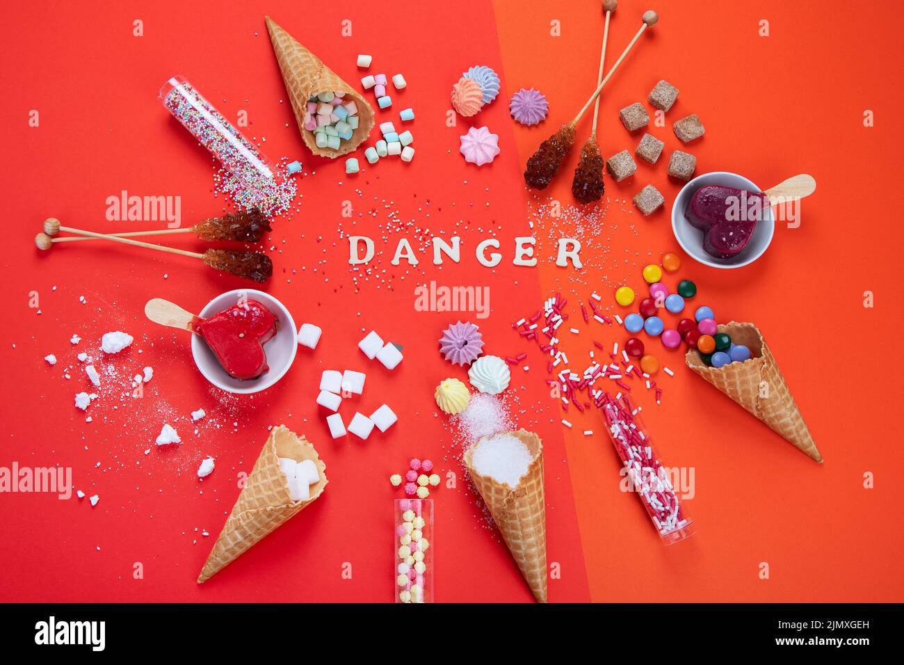 Mix of sweets and candy with sugar spread and written text in unhealthy ...