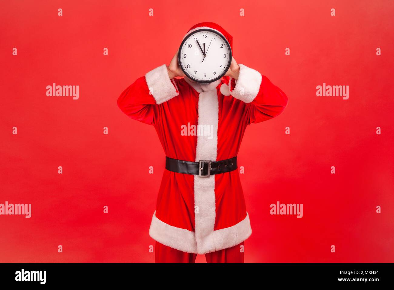 Portrait of unknown man in santa claus costume standing covering face ...