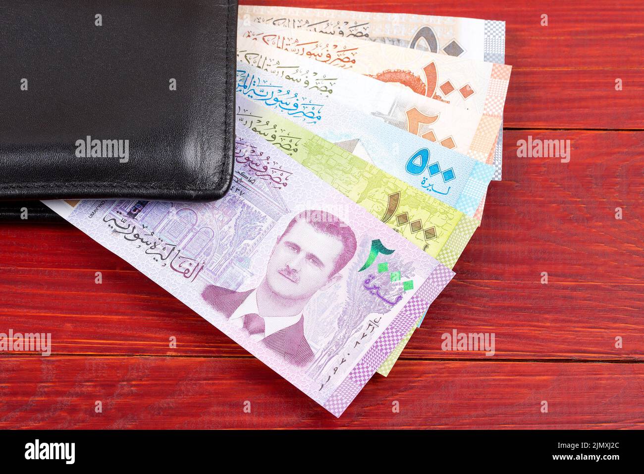 Syrian pound in the black wallet Stock Photo - Alamy