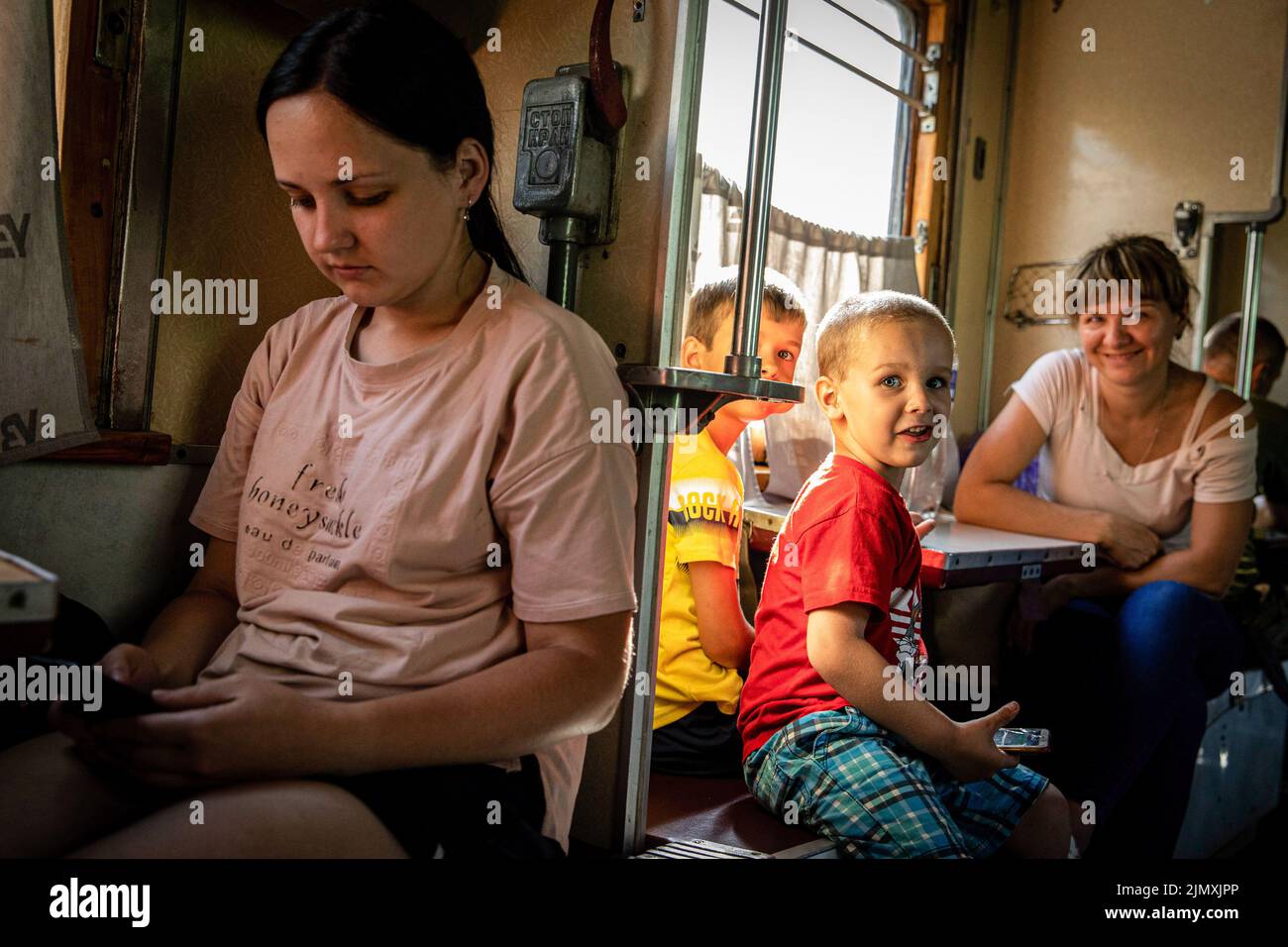 Mother Yulia (R) along with two of her children Cyrille (R2) and Lengor ...