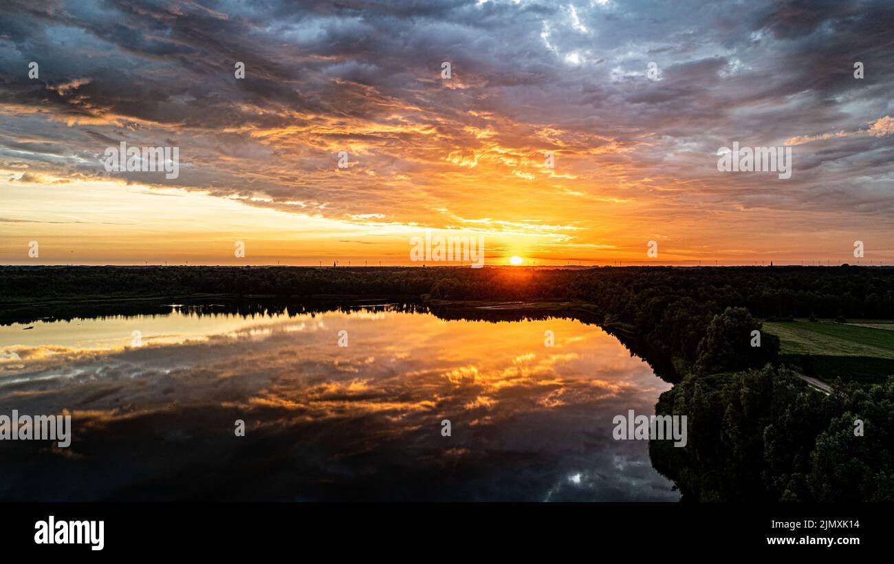 Aerial view, shot by a drone of a sunset at coast of the lake. Nature ...