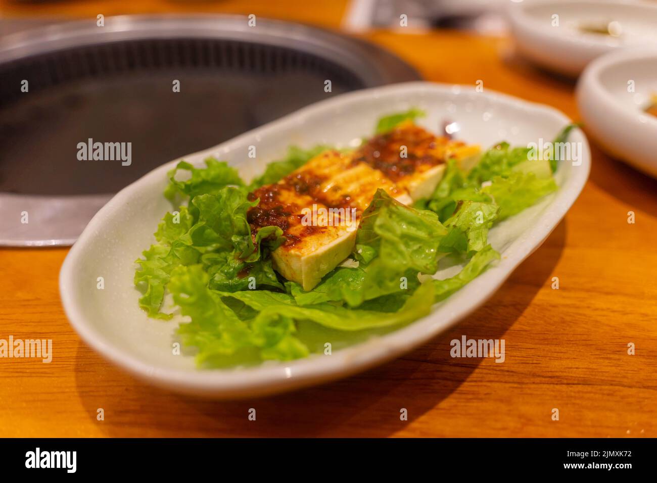 Tofu with Korean spicy soy and sesame oil sauce, salad. Food and travel ...