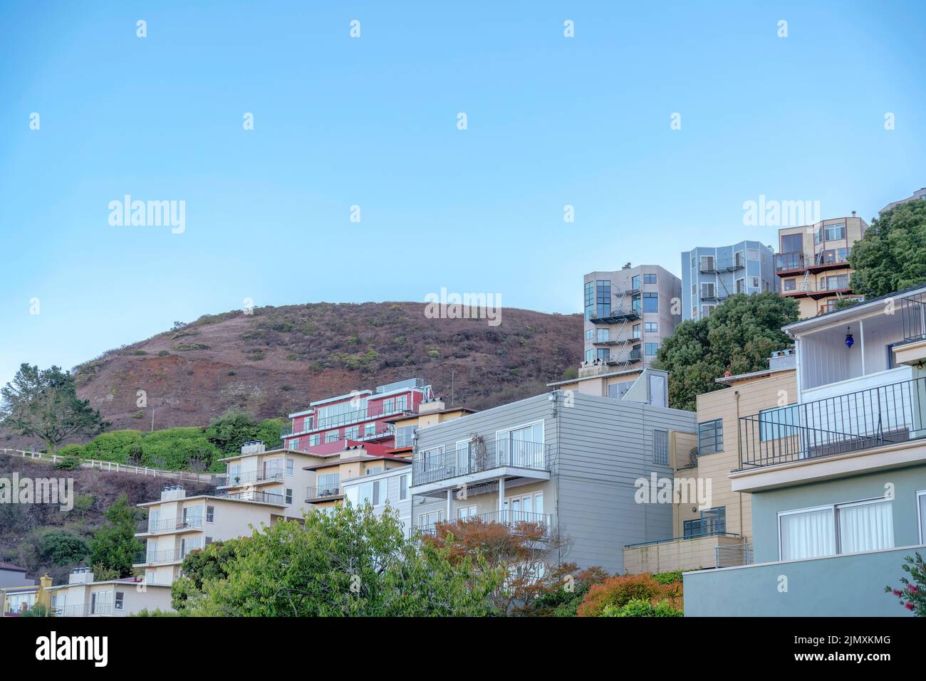 Apartment buildings on a slope with balconies near the mountain in San ...