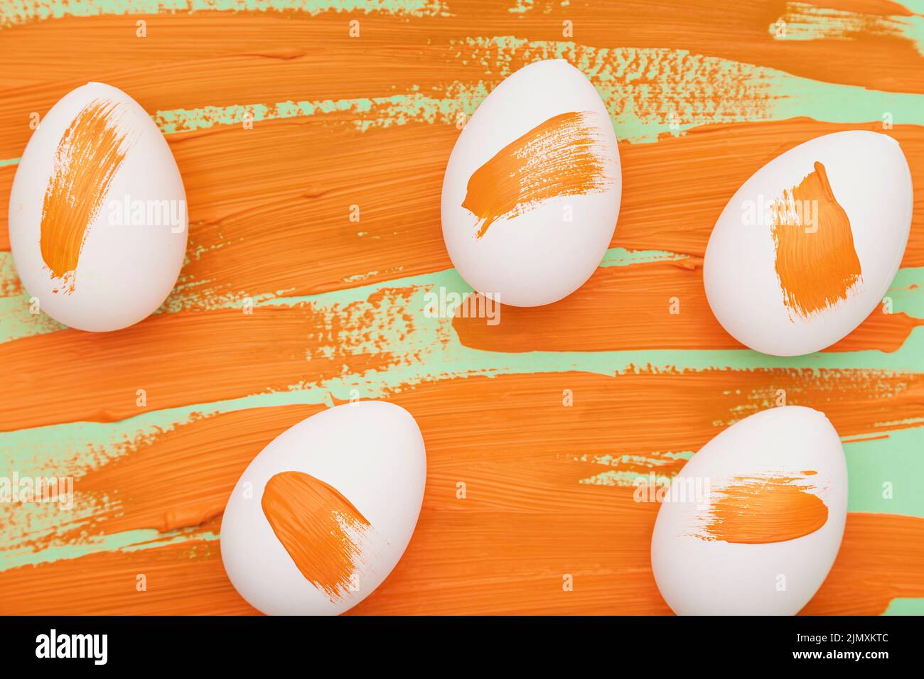 Top view eggs with watercolor orange strikes Stock Photo - Alamy