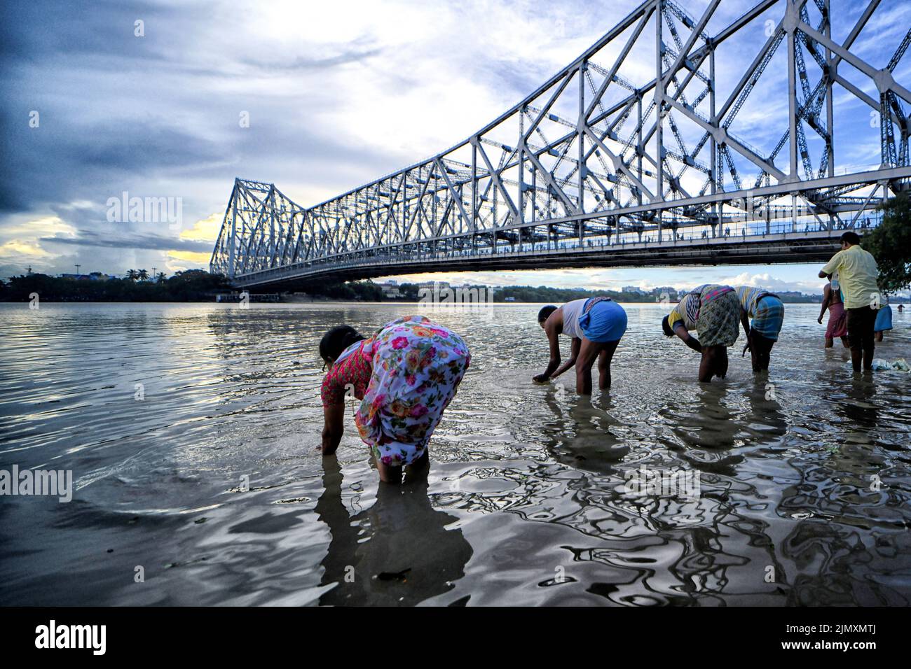 Local people seen washing their hands and clothes in the river Ganges ...