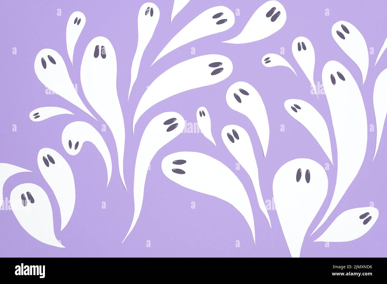 Halloween design, group of cute white ghosts flying on lilac background ...