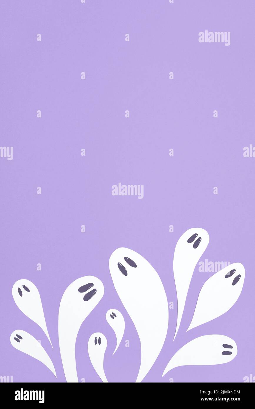 Halloween design, group of cute white ghosts flying on lilac background ...