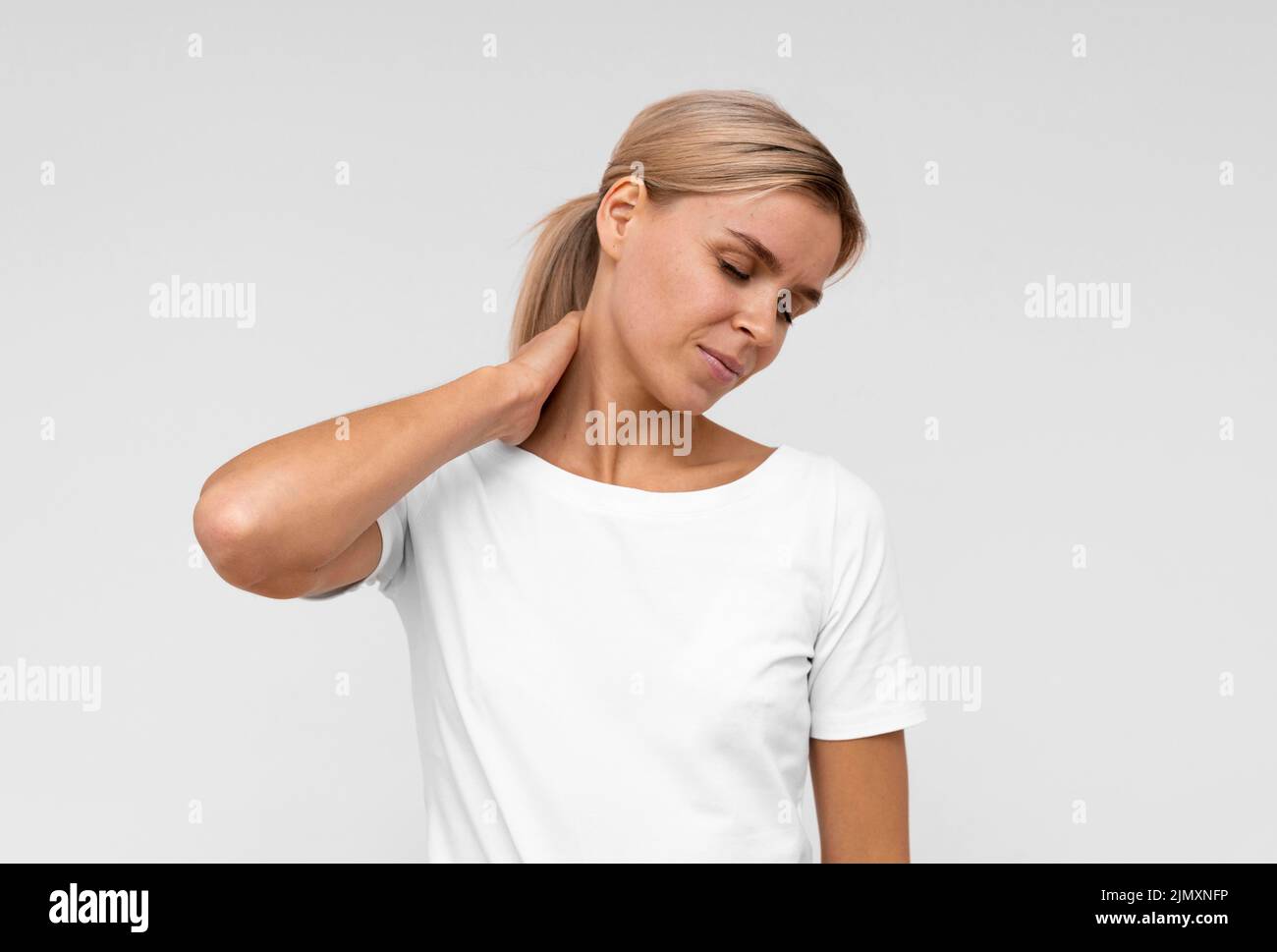 Front view woman with neck pain Stock Photo - Alamy
