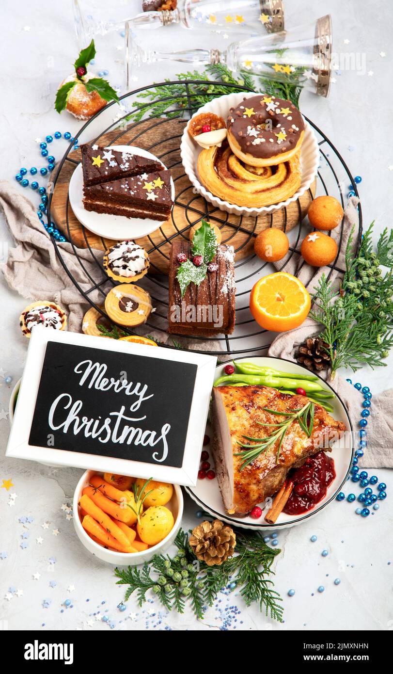 Delicious Christmas themed dinner table with roasted meat, potato ...