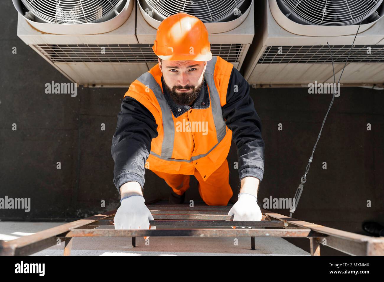 Man climbing ladder hi-res stock photography and images - Alamy