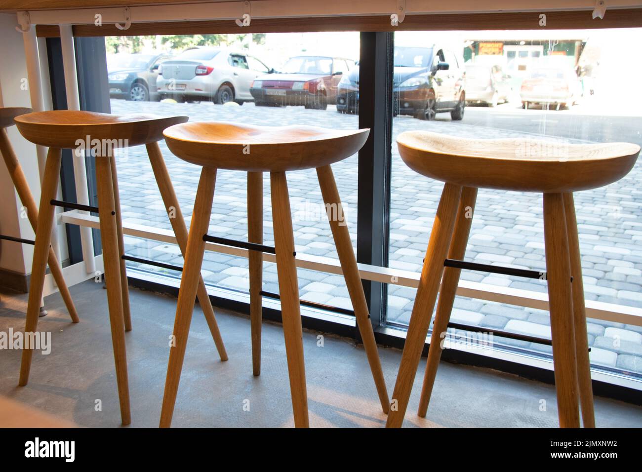 wooden chairs near the bar near the window showcase, bar interior ...