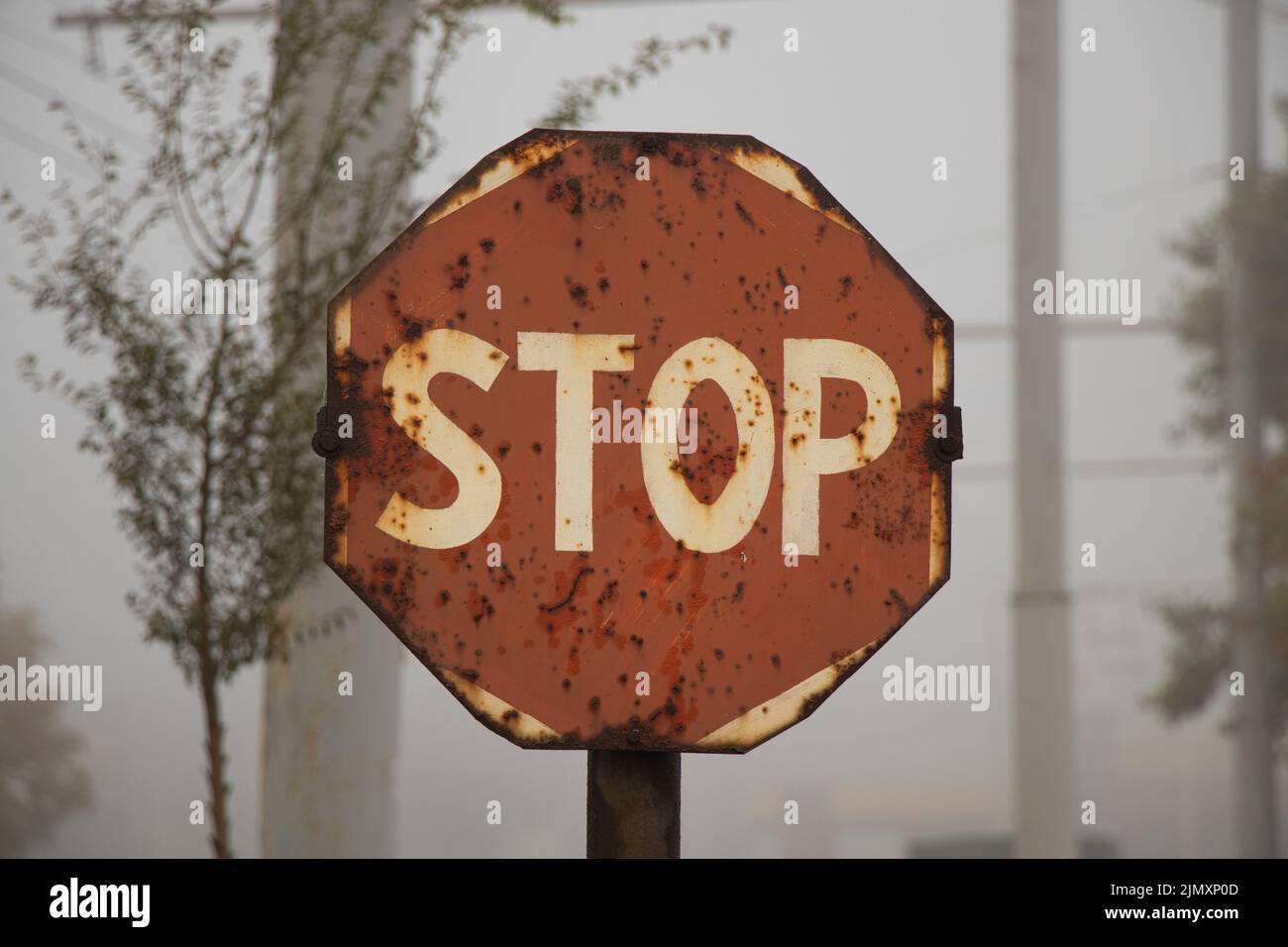 stop sign old rusty morning in the fog in the city of Dnipro drove ...