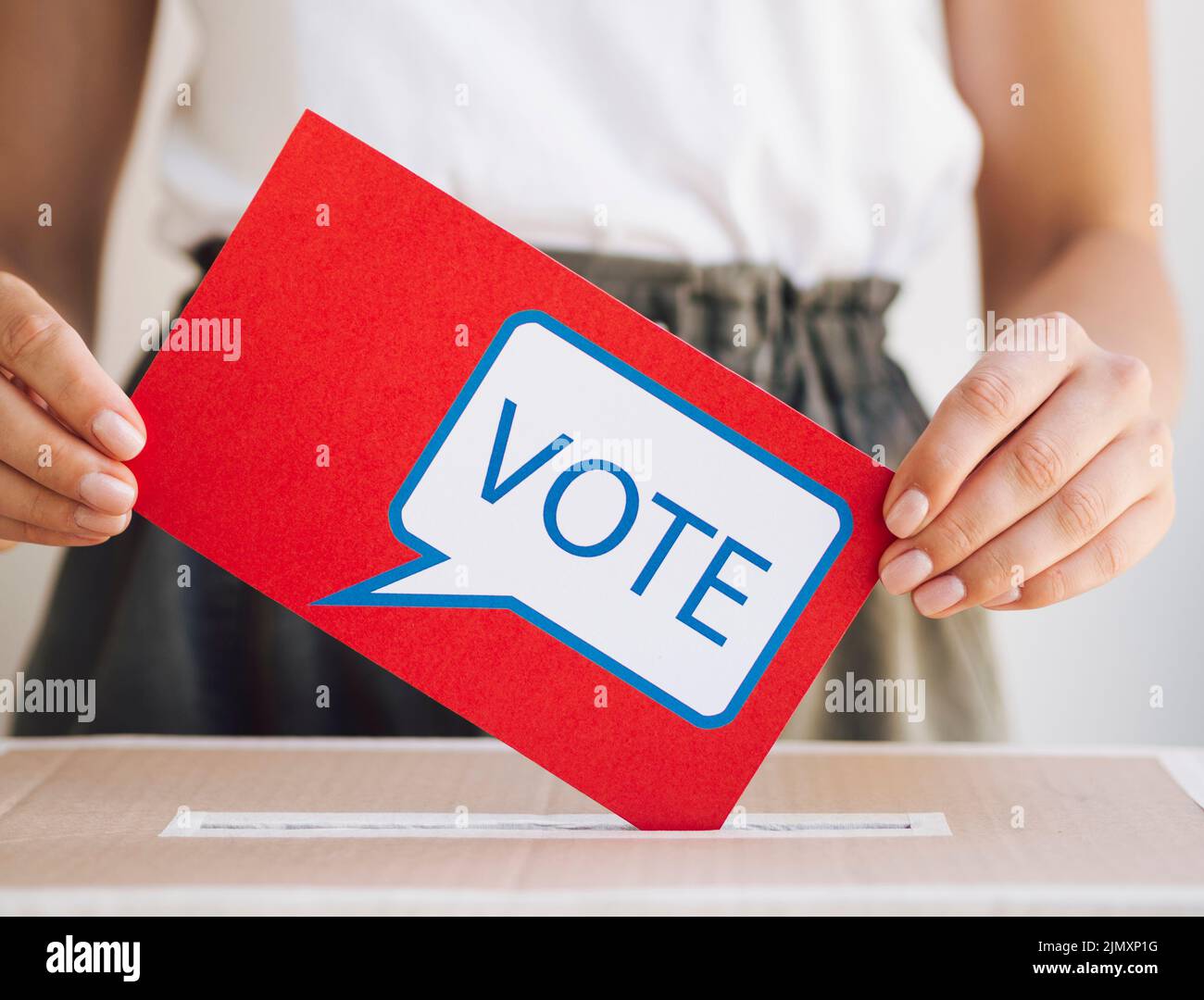 Front view woman putting voting message box Stock Photo - Alamy