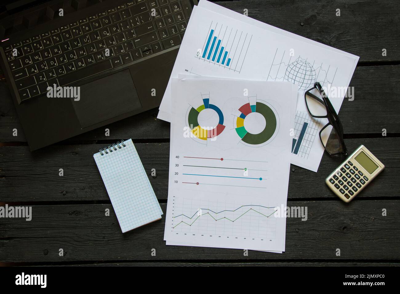 reports and histograms on paper on the table, analytics and statistics ...