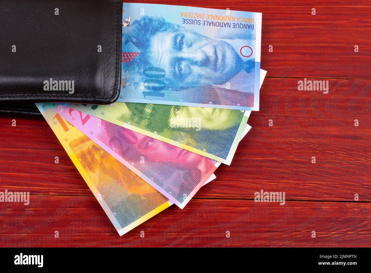 Swiss money in the black wallet Stock Photo - Alamy