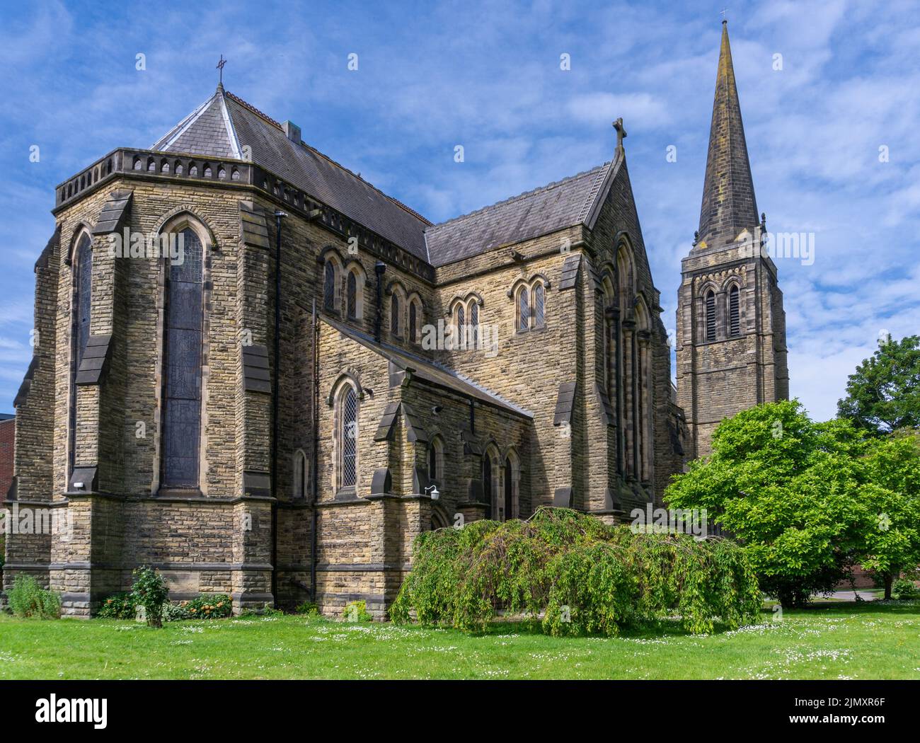 The 12th-century Gothic York Minster under a blue sky with small white ...