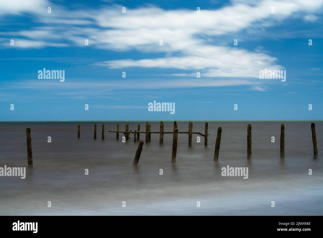 Long exposure view of old abandoned sea defenses on Happisburgh Beach ...