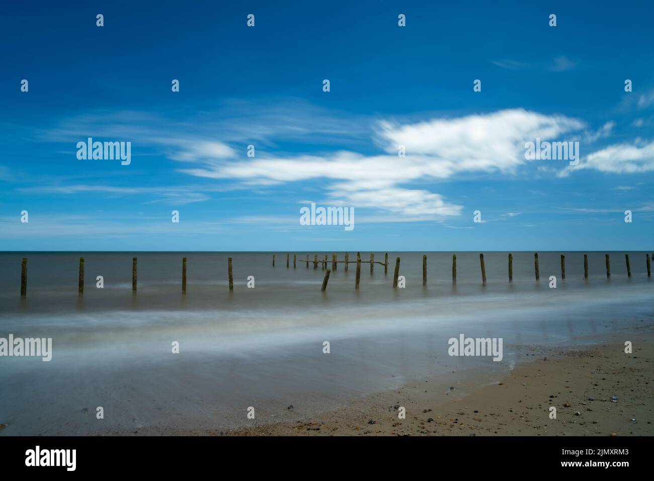 Long exposure view of old abandoned sea defenses on Happisburgh Beach ...