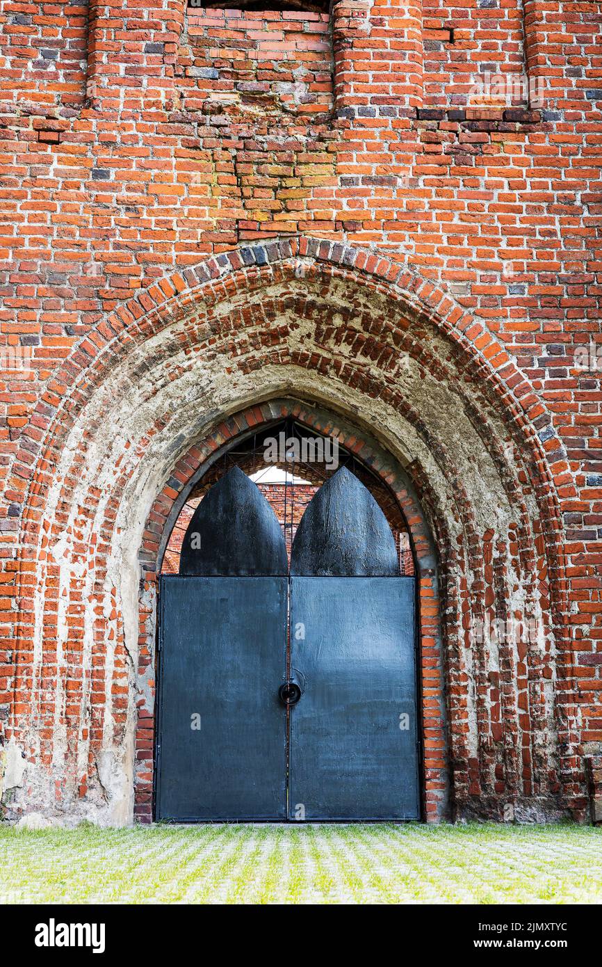 Old castle stone wall with closed big metal doors. Vintage gates. Retro ...
