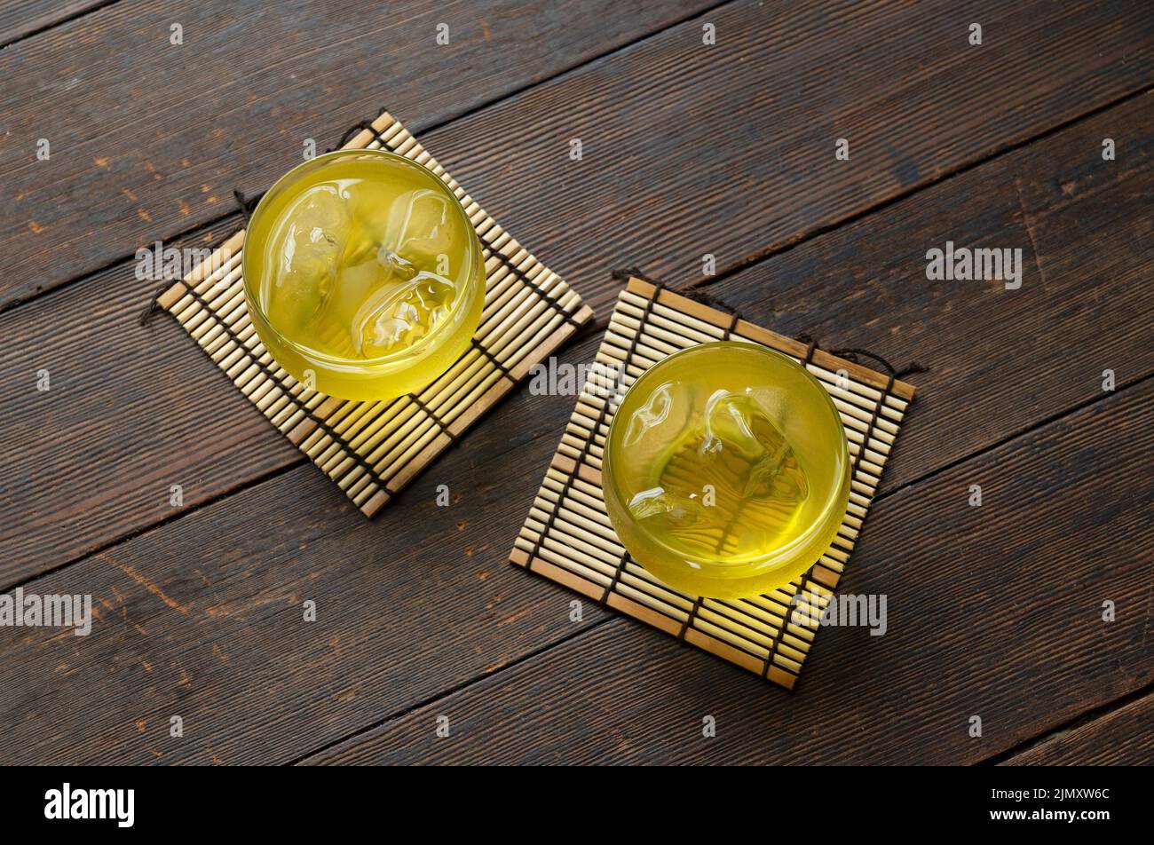 Cold Japanese green tea placed against a wooden background. Green tea ...