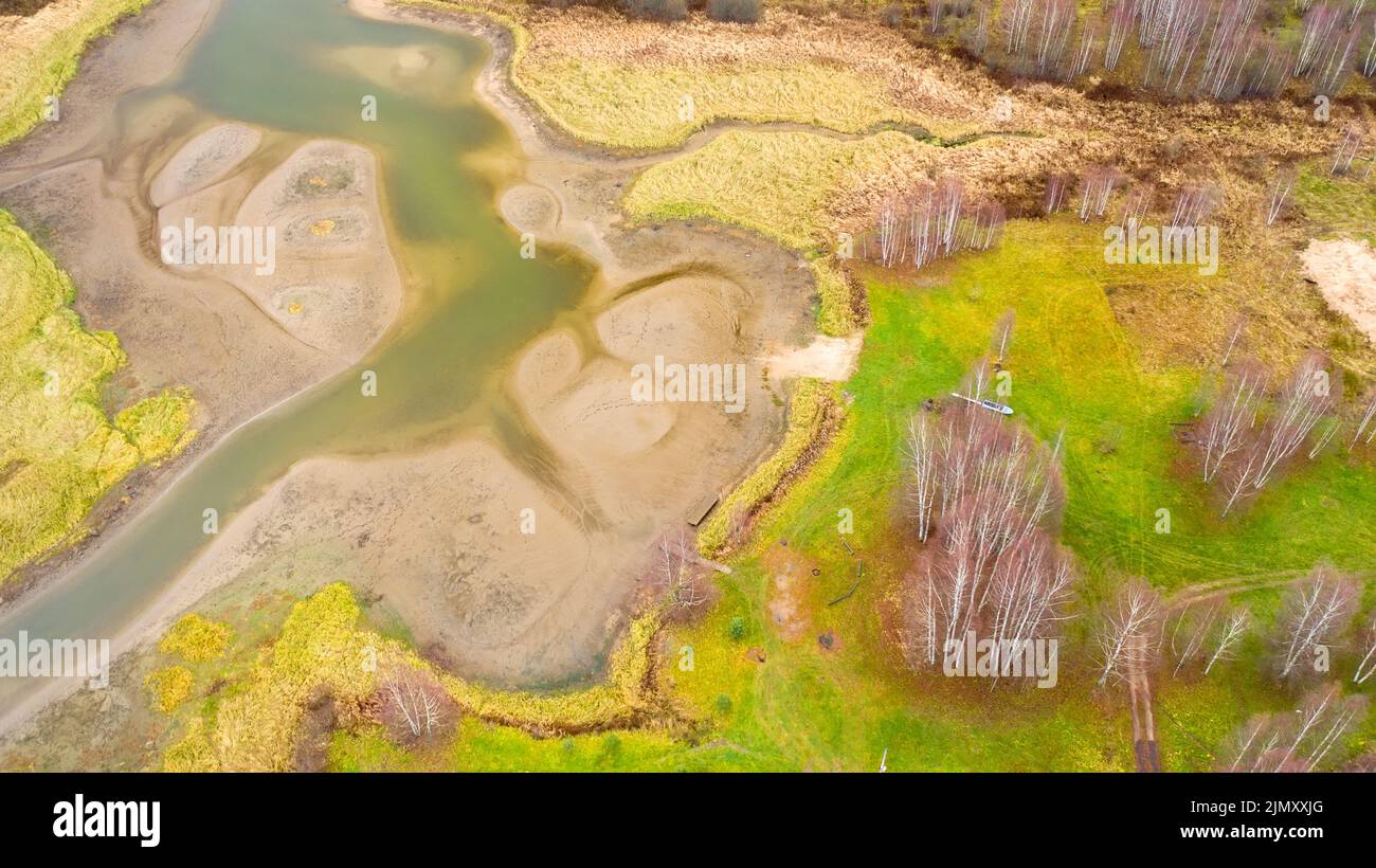 Aerial view of beautiful curving river at sunrise in autumn. View from ...