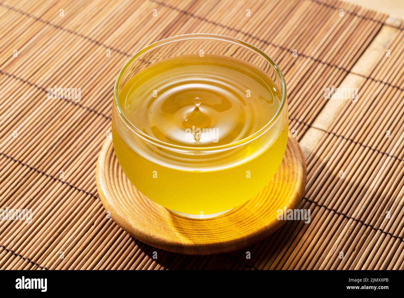 Cold Japanese tea on a bamboo luncheon mat.One drop Stock Photo - Alamy