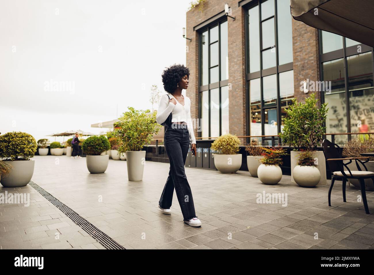 Portrait of attractive young woman walking outside in the city Stock ...