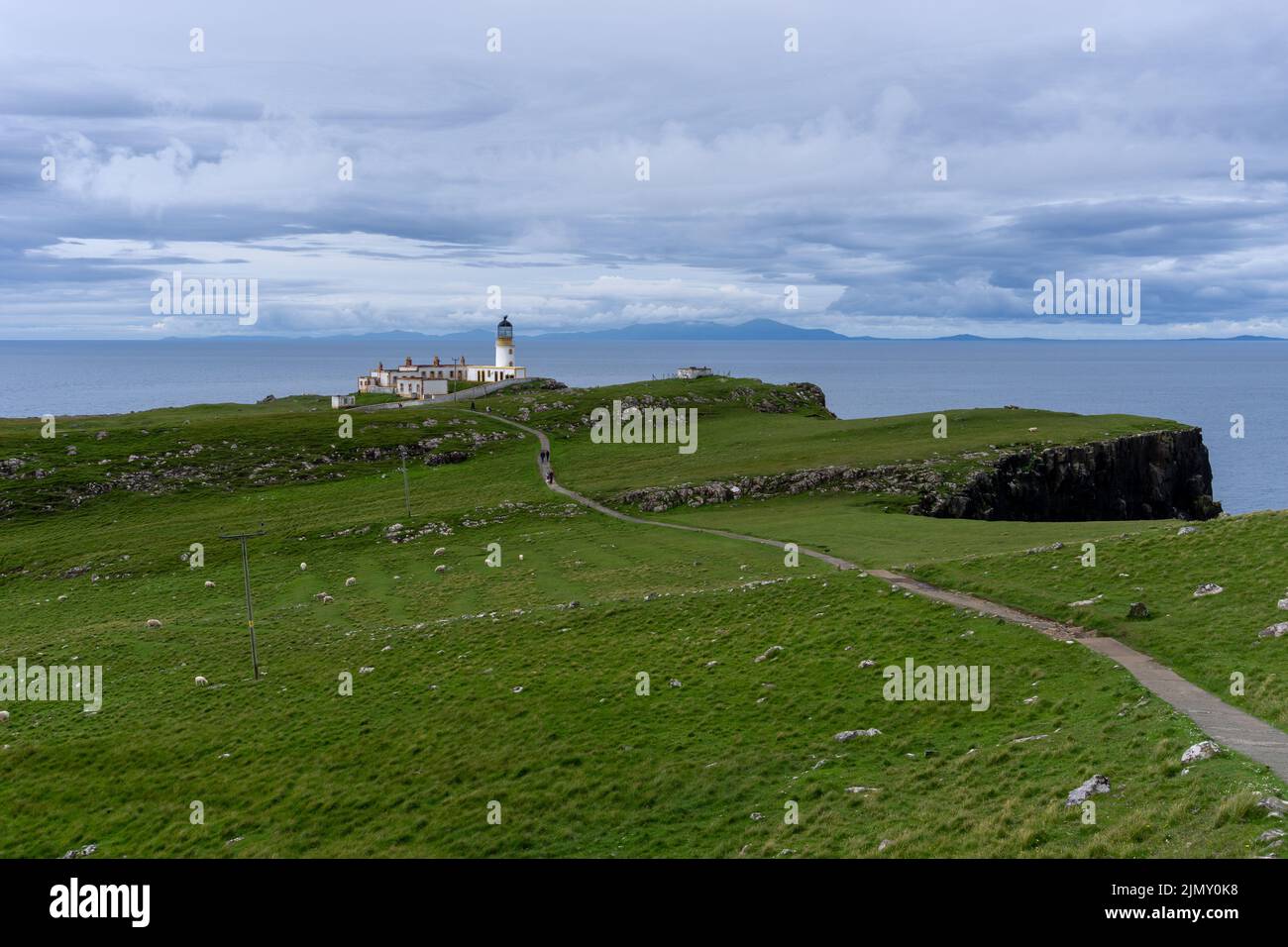 The Neist Point Lighthouse on the green cliffs of the Isle of Skye ...