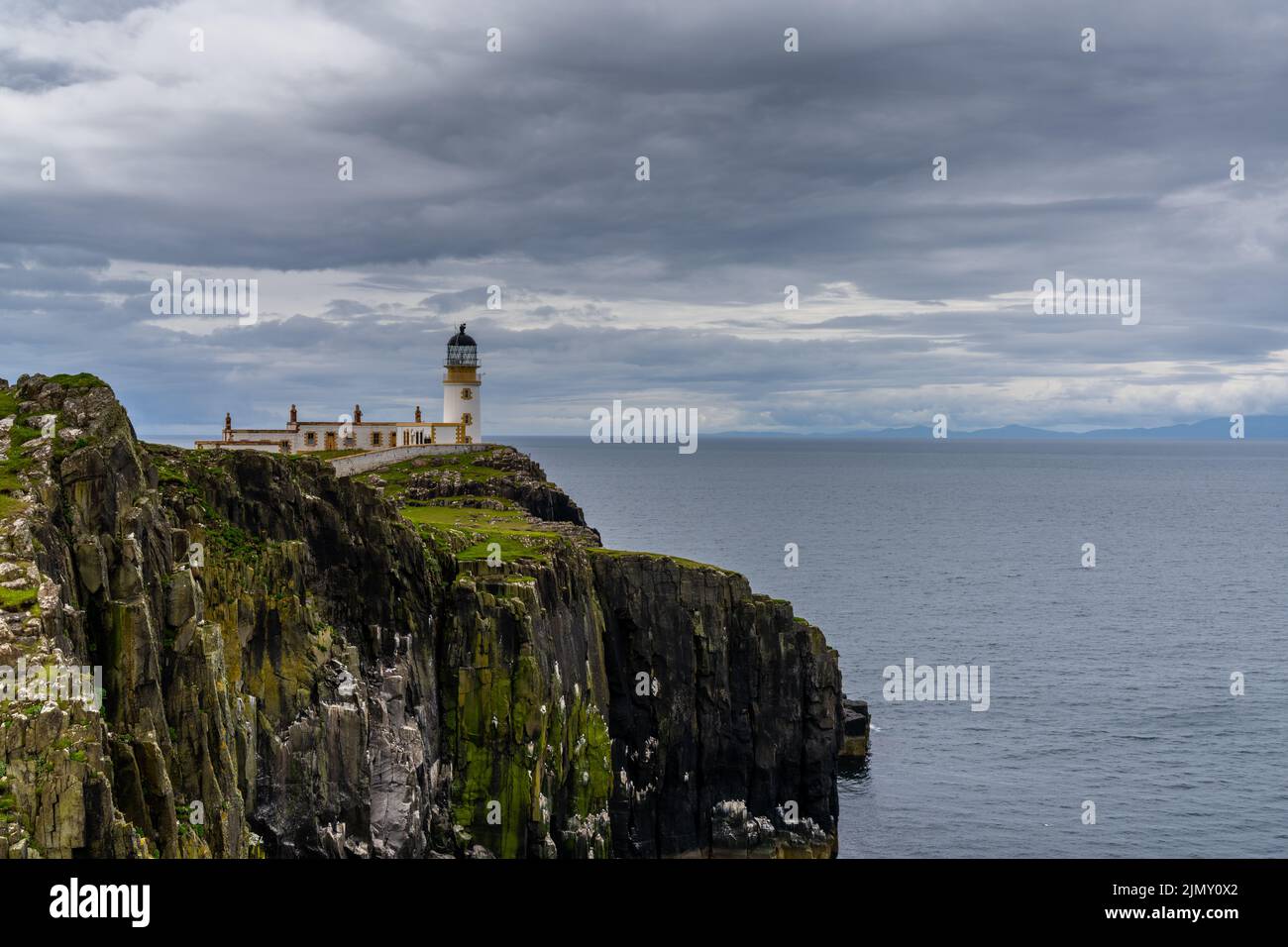 The Neist Point Lighthouse on the green cliffs of the Isle of Skye ...